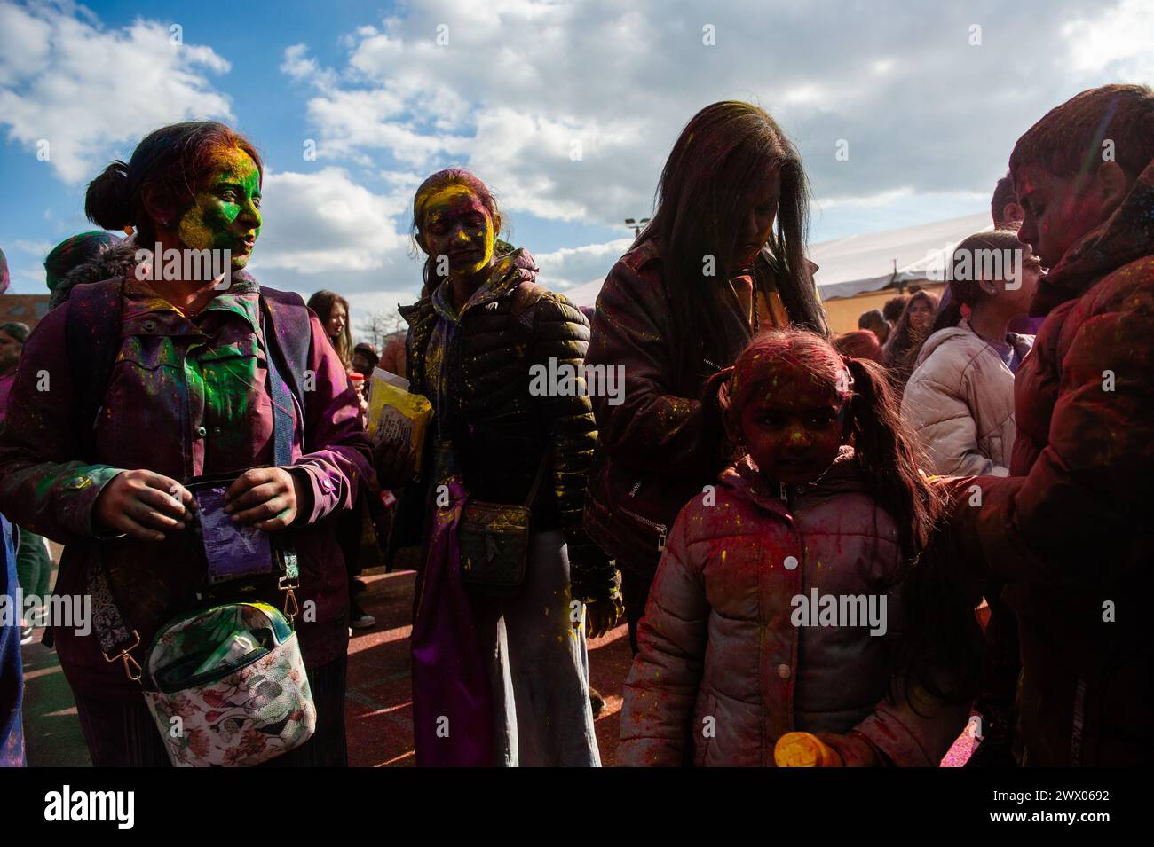 An Indian family is seen checking their clothes full of colorful powder ...