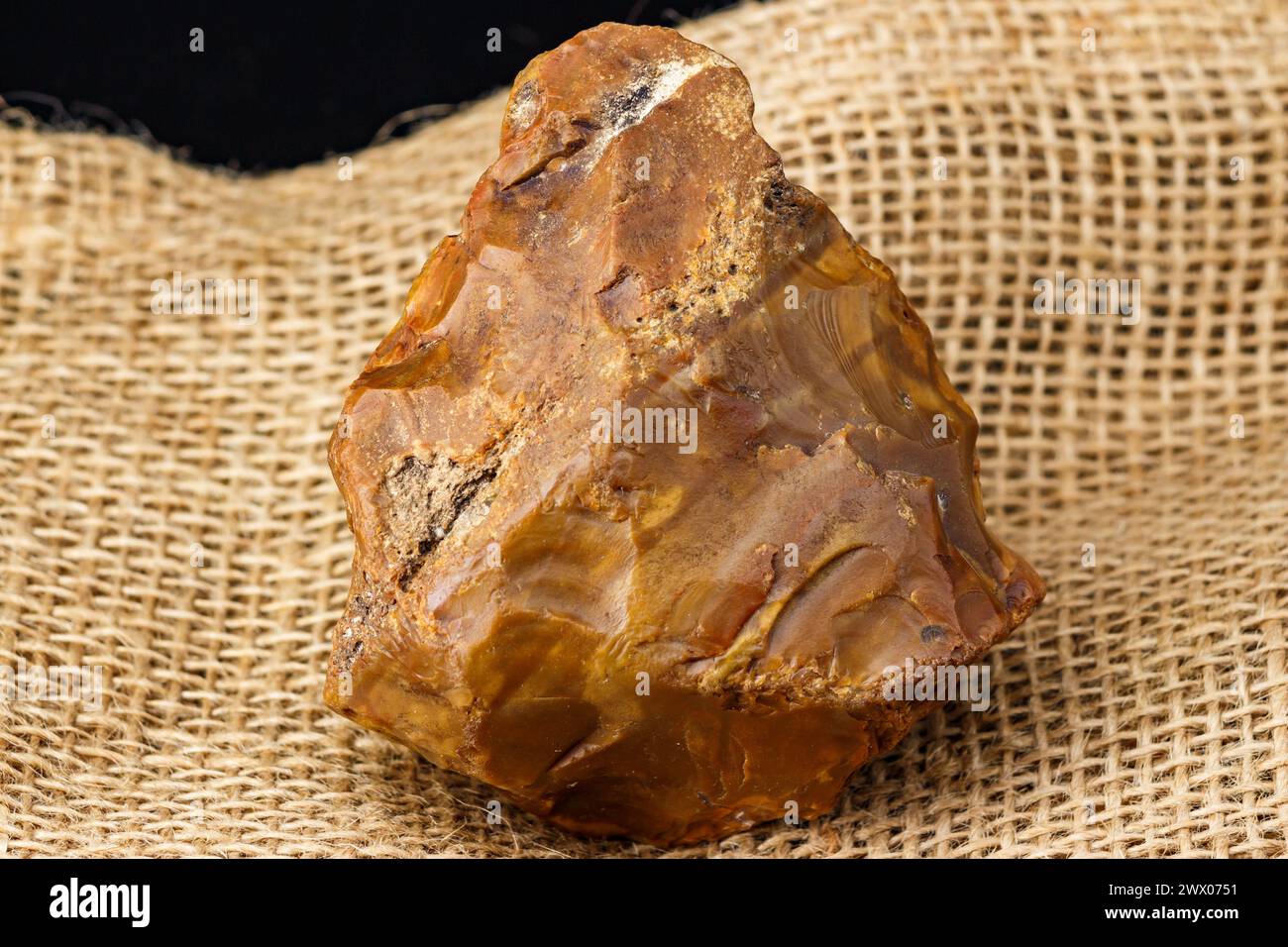 Stone ax made of brown flint, a Stone Age tool with rough retouching ...