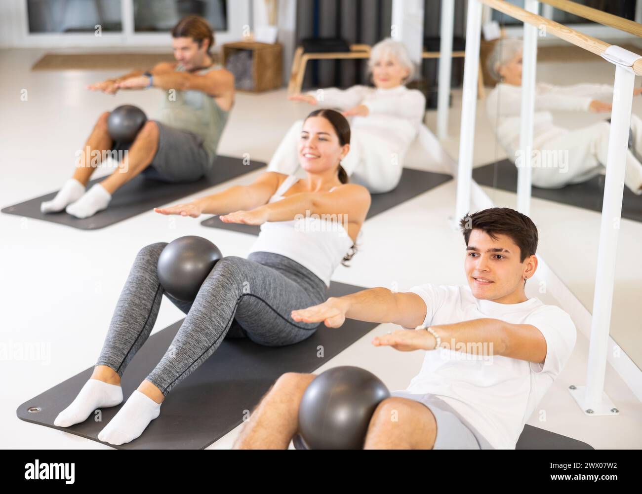 Group of different people doing exercises with ball Stock Photo - Alamy