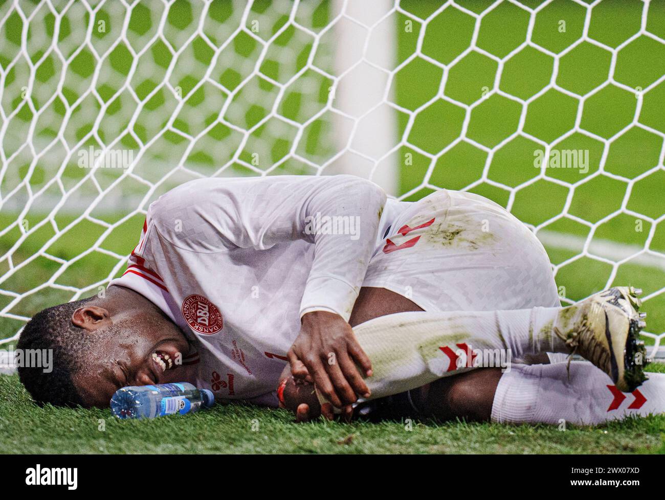 Denmark's Mohamed Daramy is injured with his knee during the friendly ...
