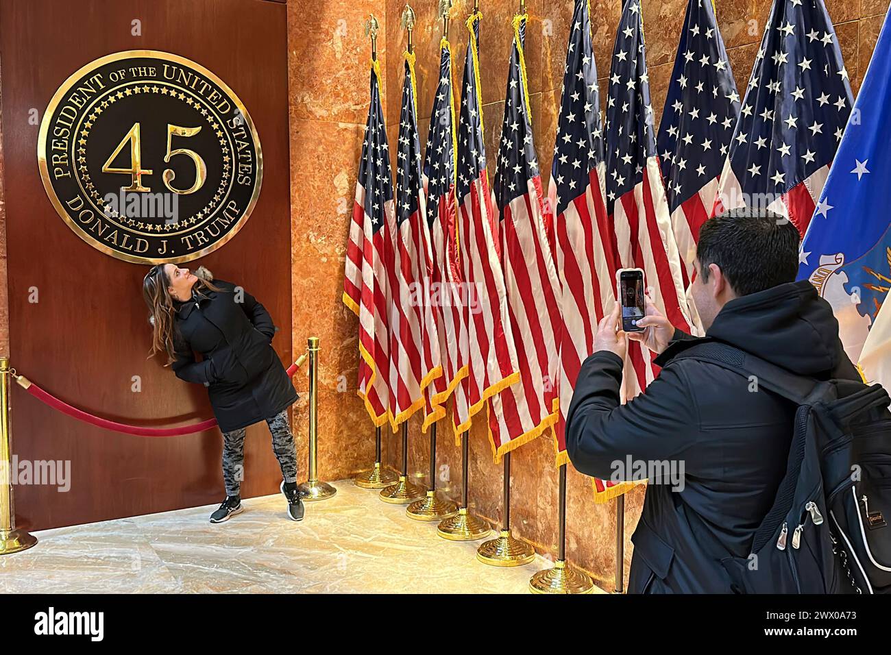 People pose for photos inside Trump Tower in New York on Friday, March ...