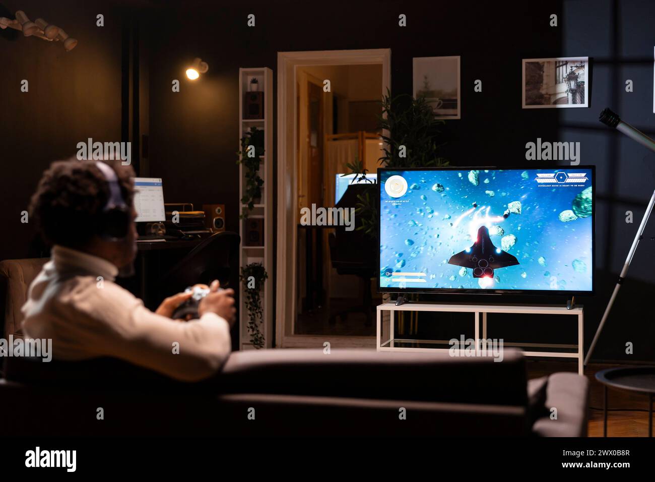 Bipoc Gamer Playing Classic Arcade Action Videogame Flying Through Space Debris Man Enjoying