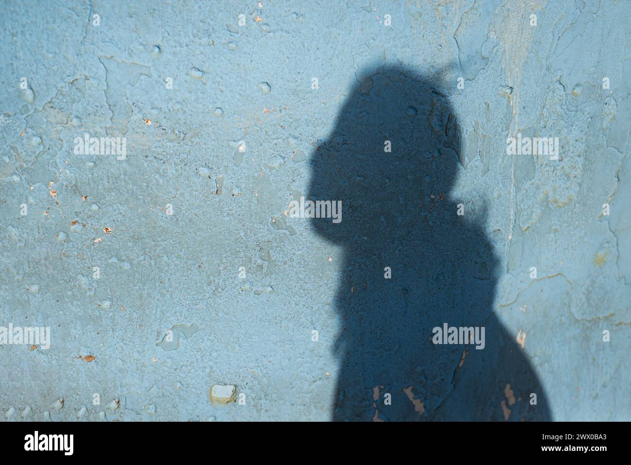 Shadow cast on a wall by an unidentified person. Texture Stock Photo ...