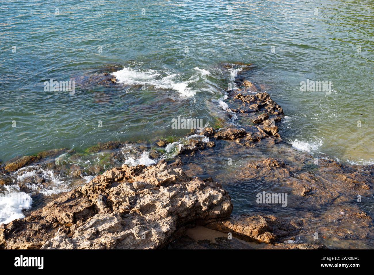Dark rocks in sea hi-res stock photography and images - Alamy