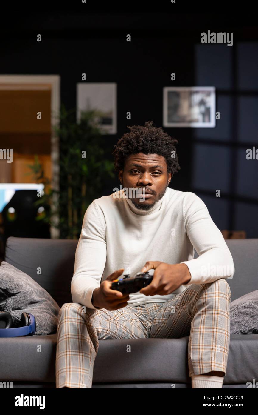 Portrait of man playing boring videogame on gaming console, feeling ...