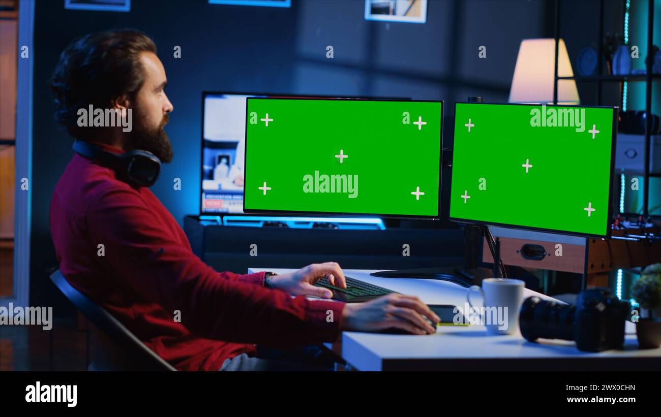 Photo editor using green screen monitor to color correct photographs in ...