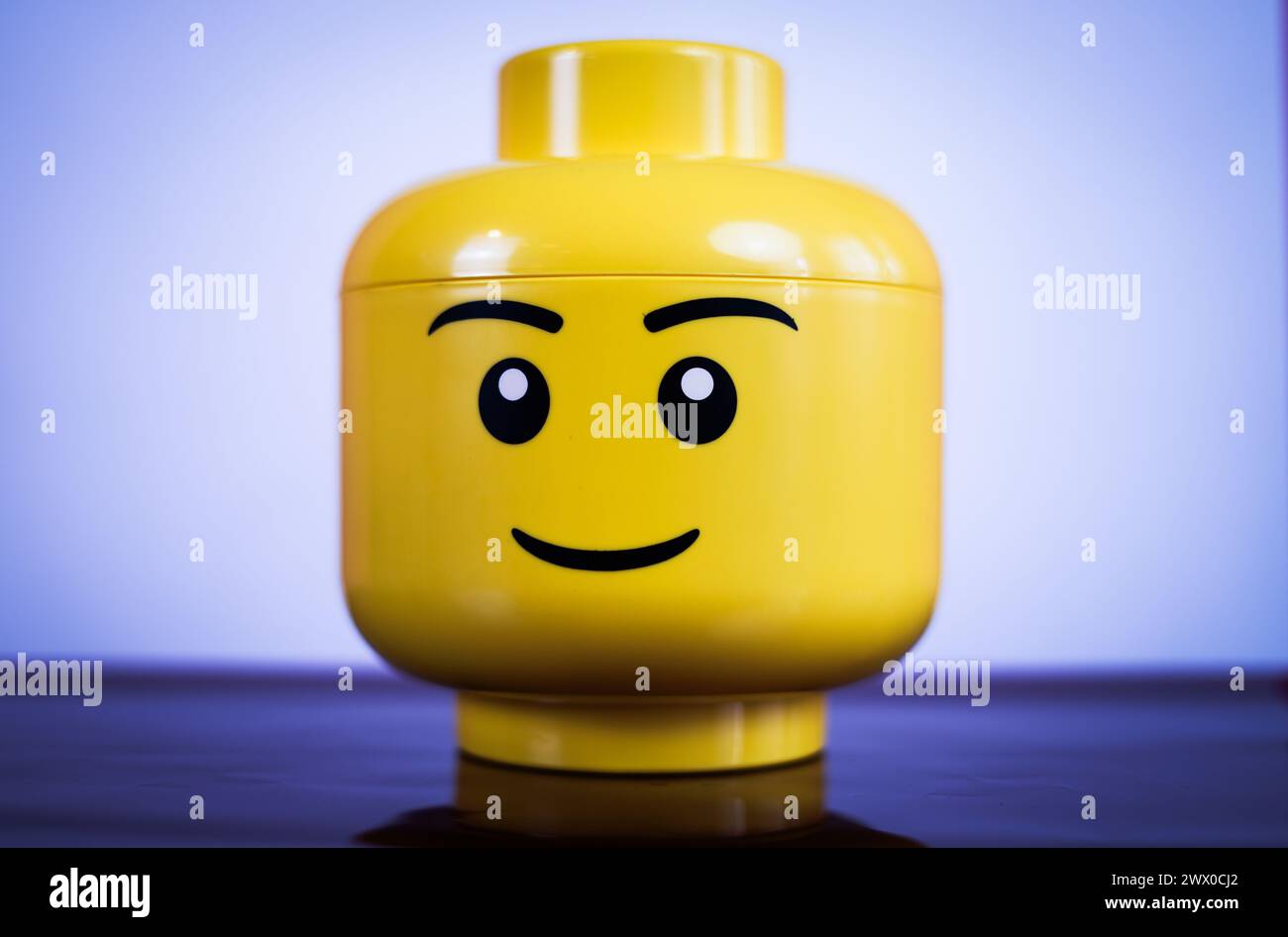 Yellow Lego Head box with blue background Stock Photo - Alamy