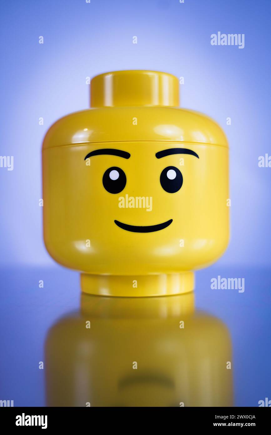 Yellow Lego Head box with blue background Stock Photo - Alamy