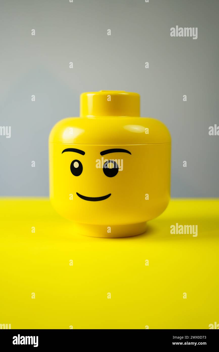 Yellow Lego Head box with blue background Stock Photo - Alamy