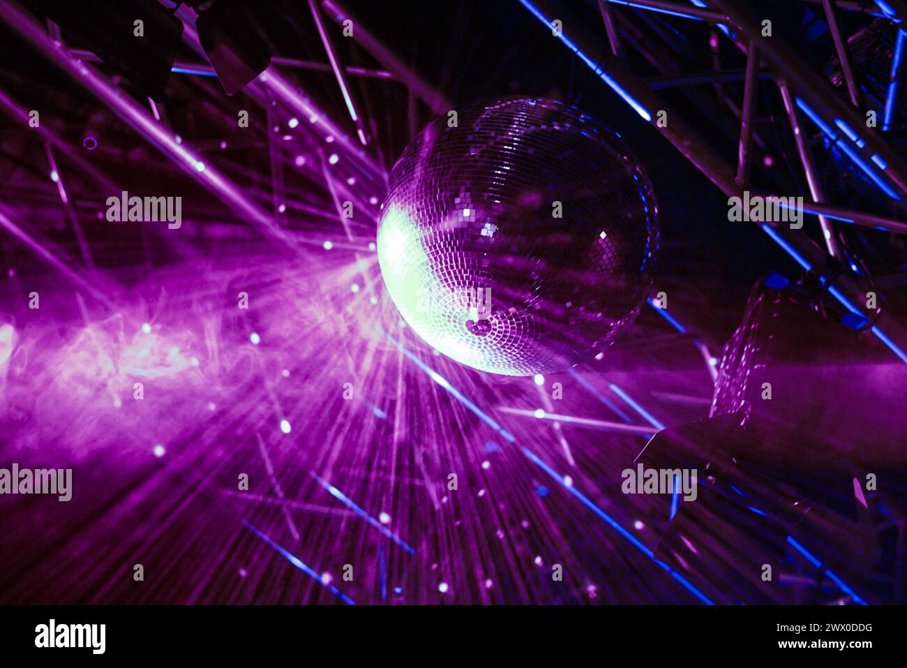 Shining disco ball with purple lights Stock Photo - Alamy