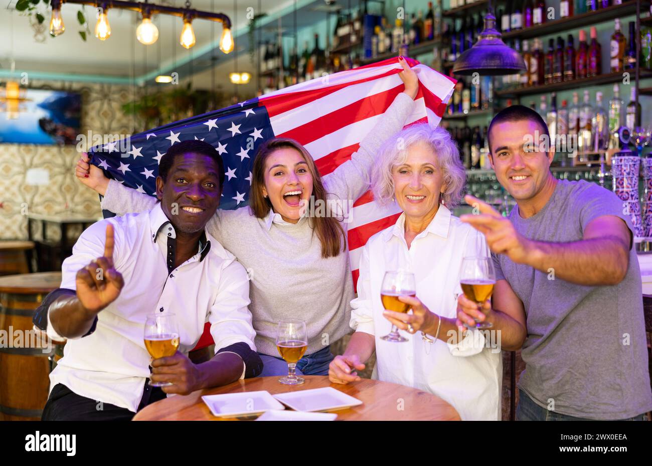Happy sport fans holding flag of United States of America, celebrating ...