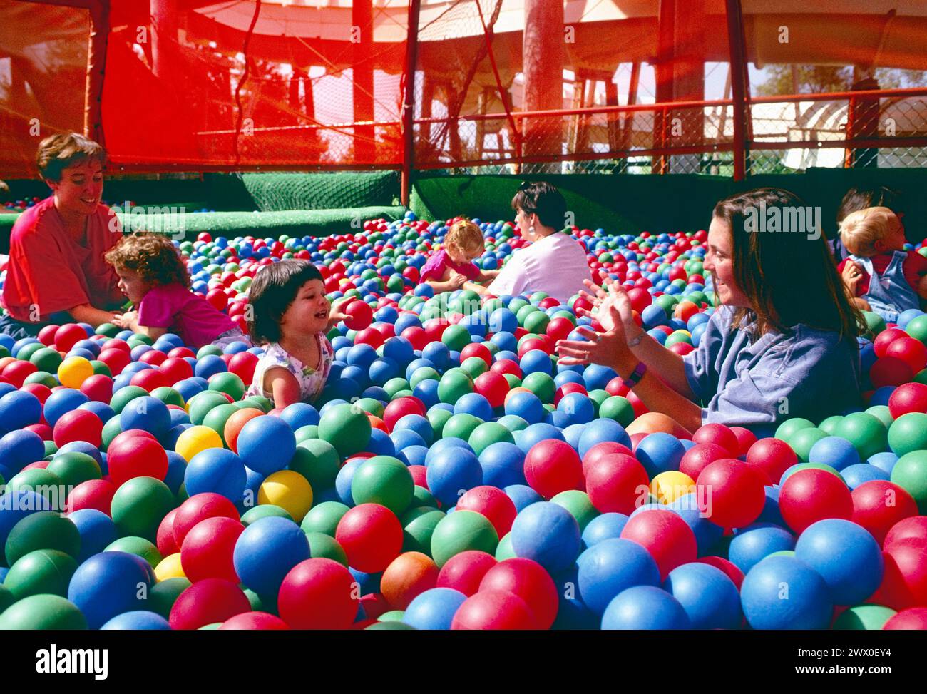 Children & adults playing in the "Snuffleballs" at Sesame Place, a ...