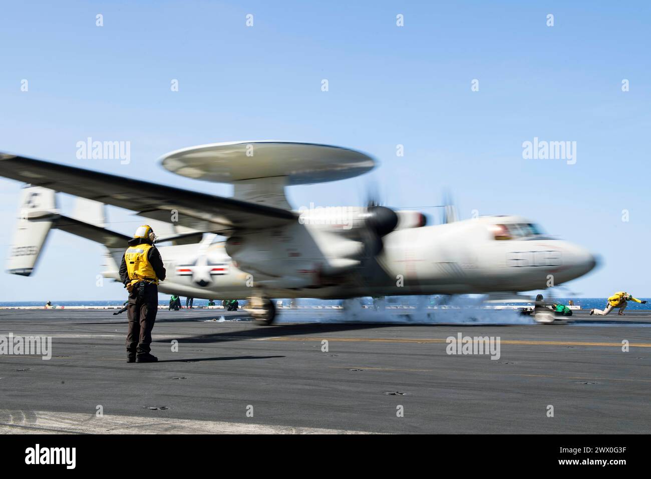 240320-N-GJ011-1026 RED SEA (March 20, 2024) Sailors observe an E-2C ...
