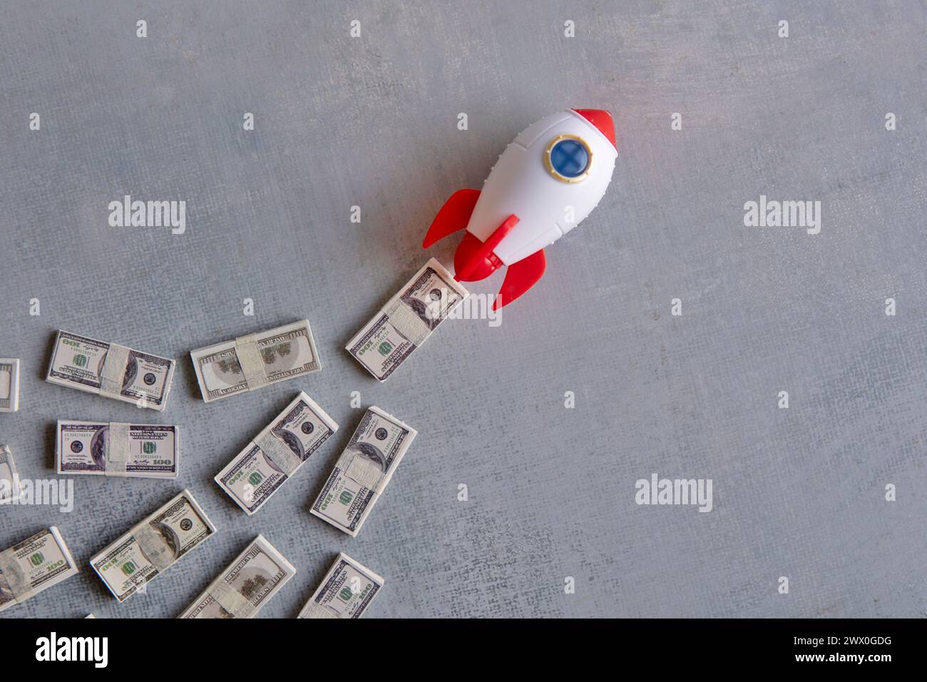 Rocket blasts off through a pile of money. Skyrocket sales, growing ...