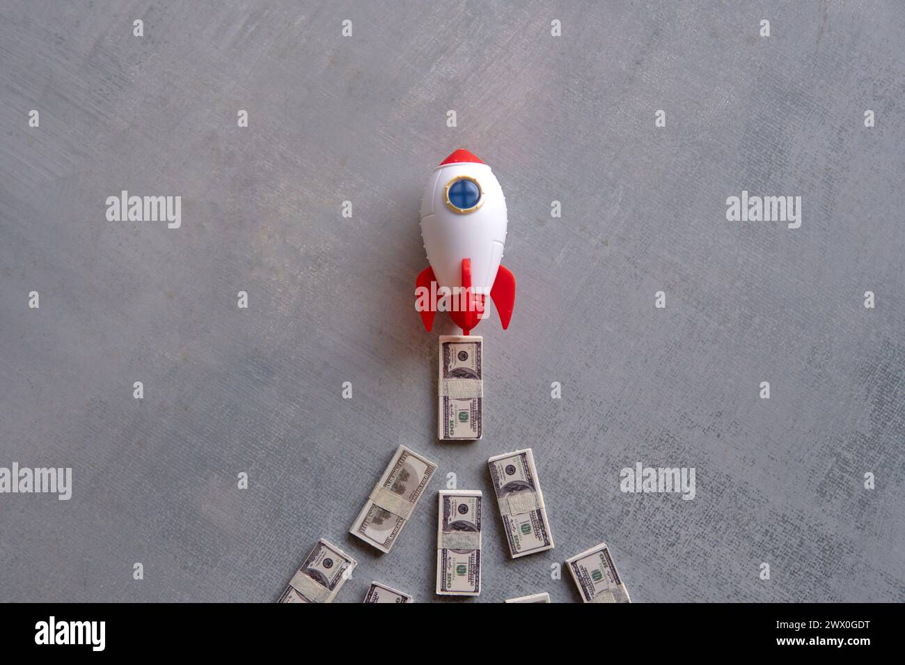 Rocket blasts off through a pile of money. Skyrocket sales, growing ...