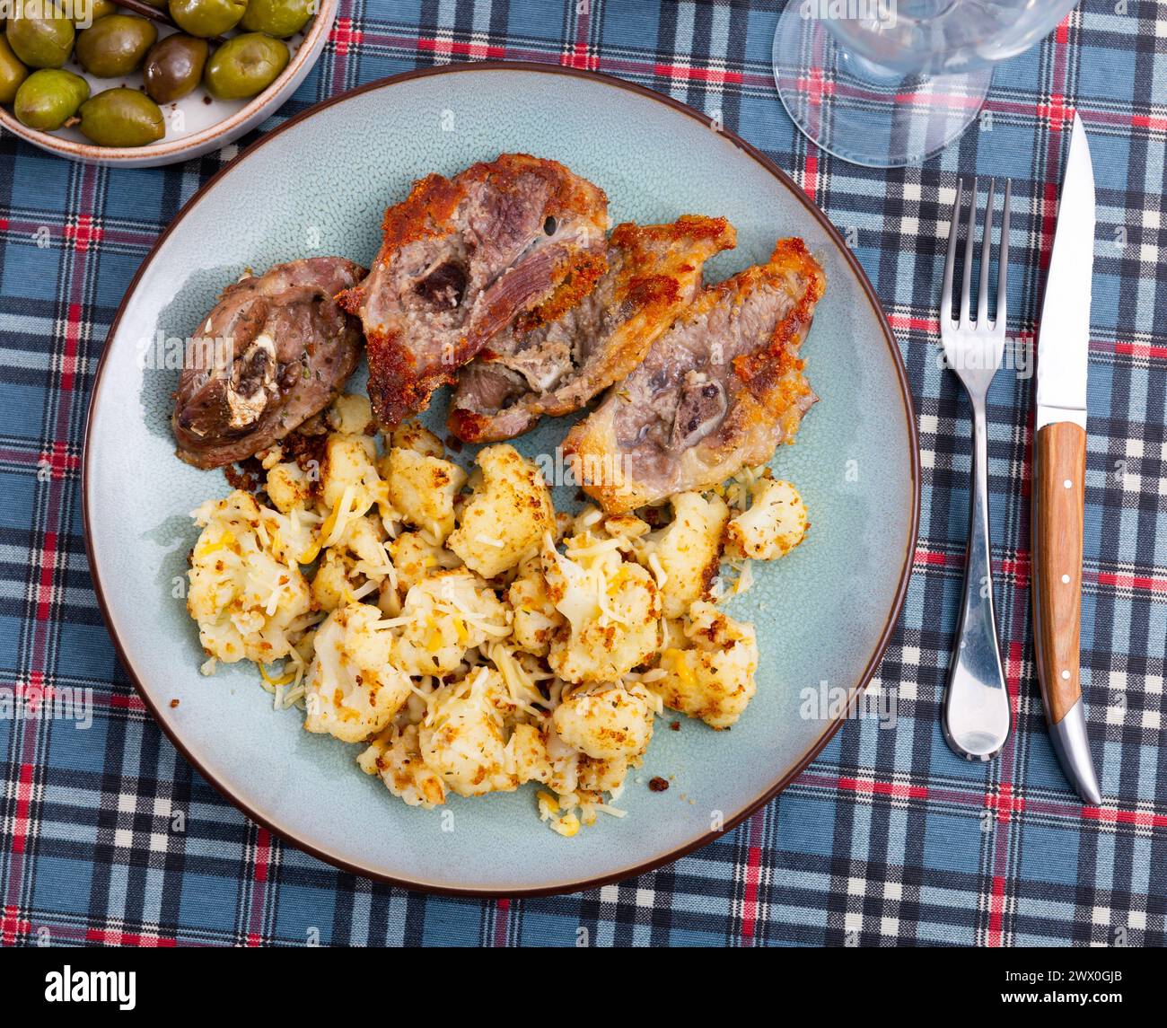 Fried lamb served with cauliflower on platter Stock Photo - Alamy