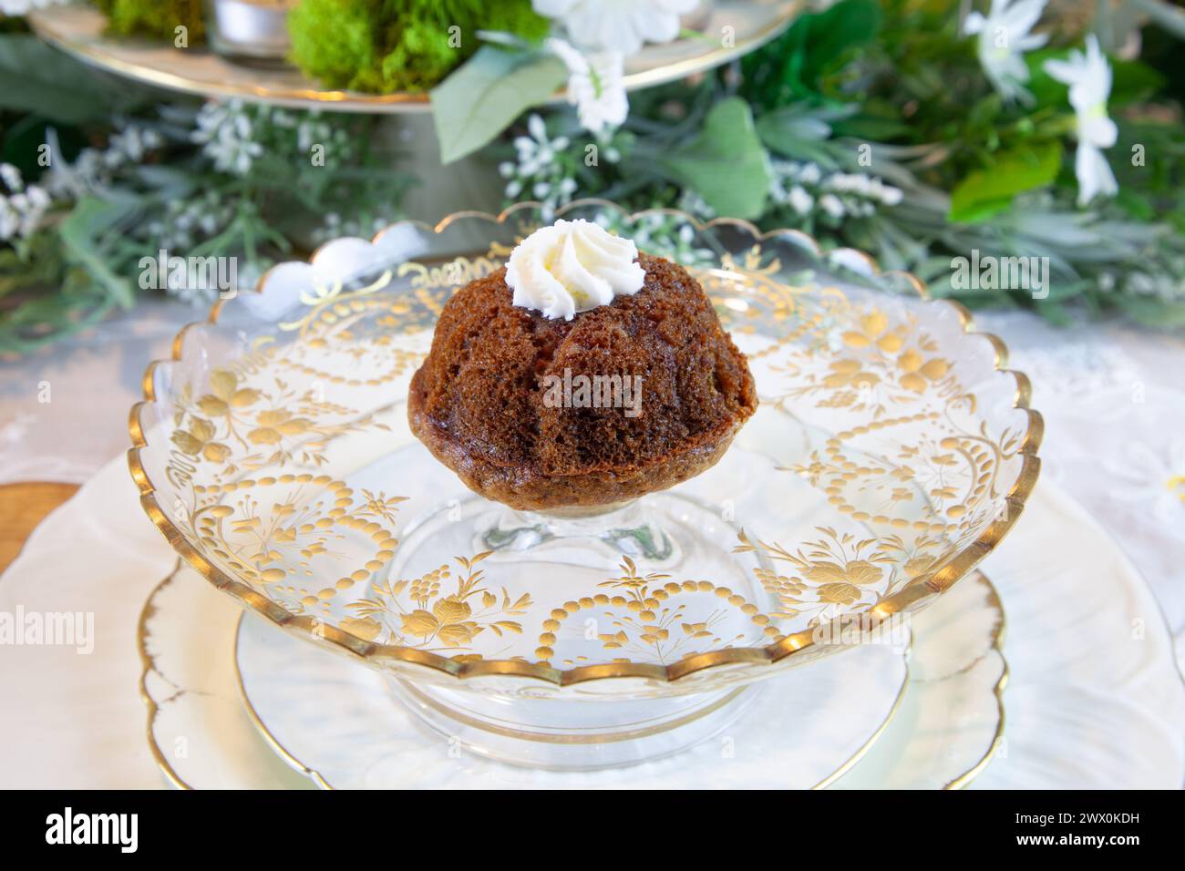 Banana bread with whipped cream served on fine China plates and crystal ...