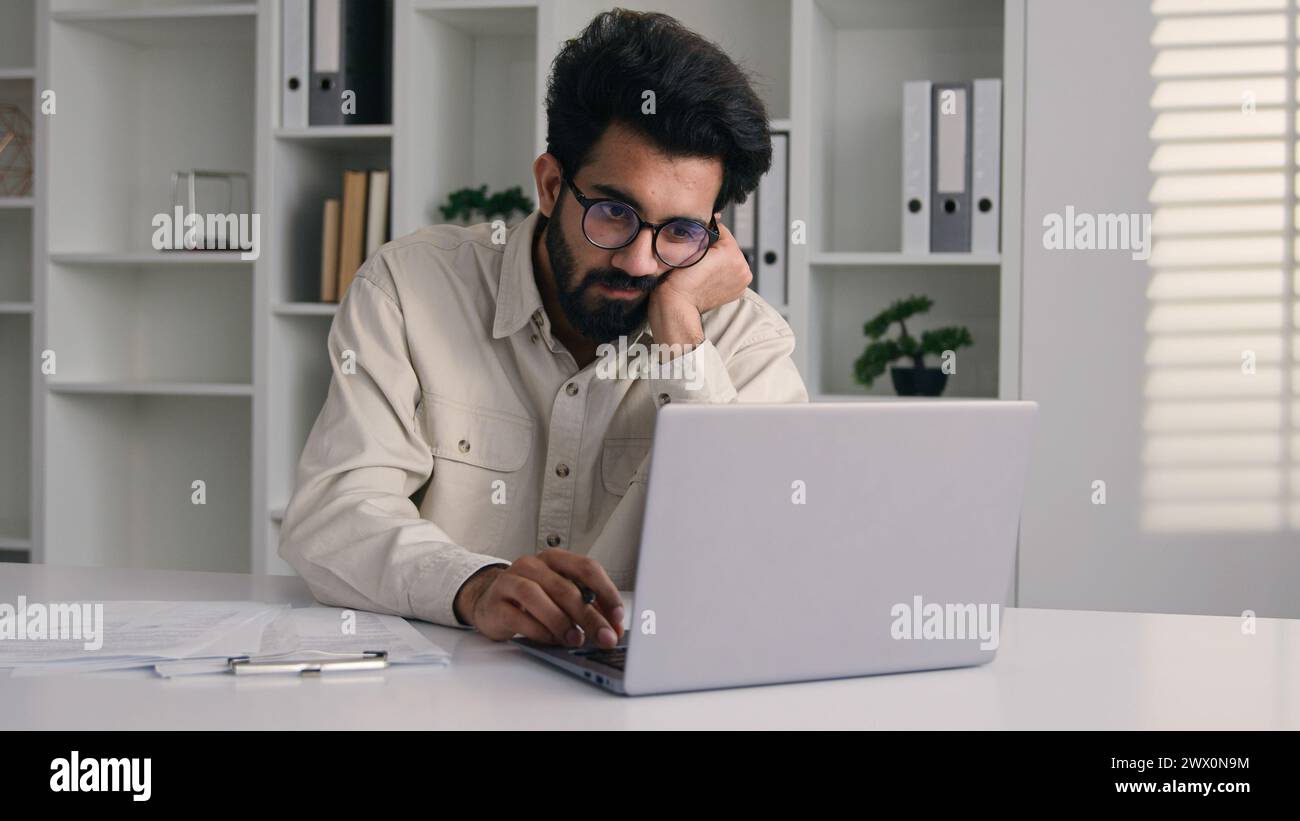 Tired Arabian muslim man overworked laptop remote job drowsy exhausted ...