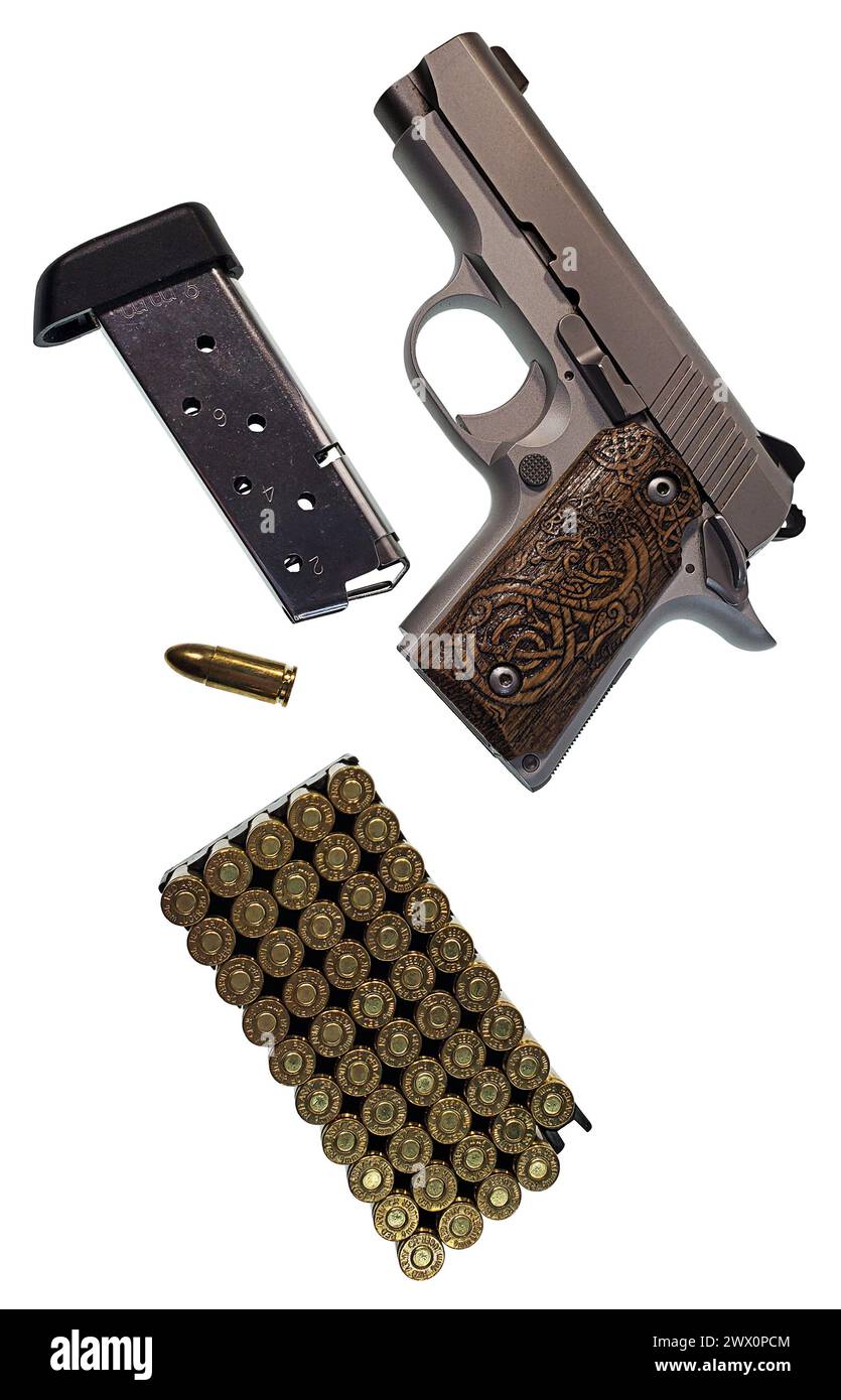 Silver metal gun with Celtic Engraved grip Stock Photo - Alamy