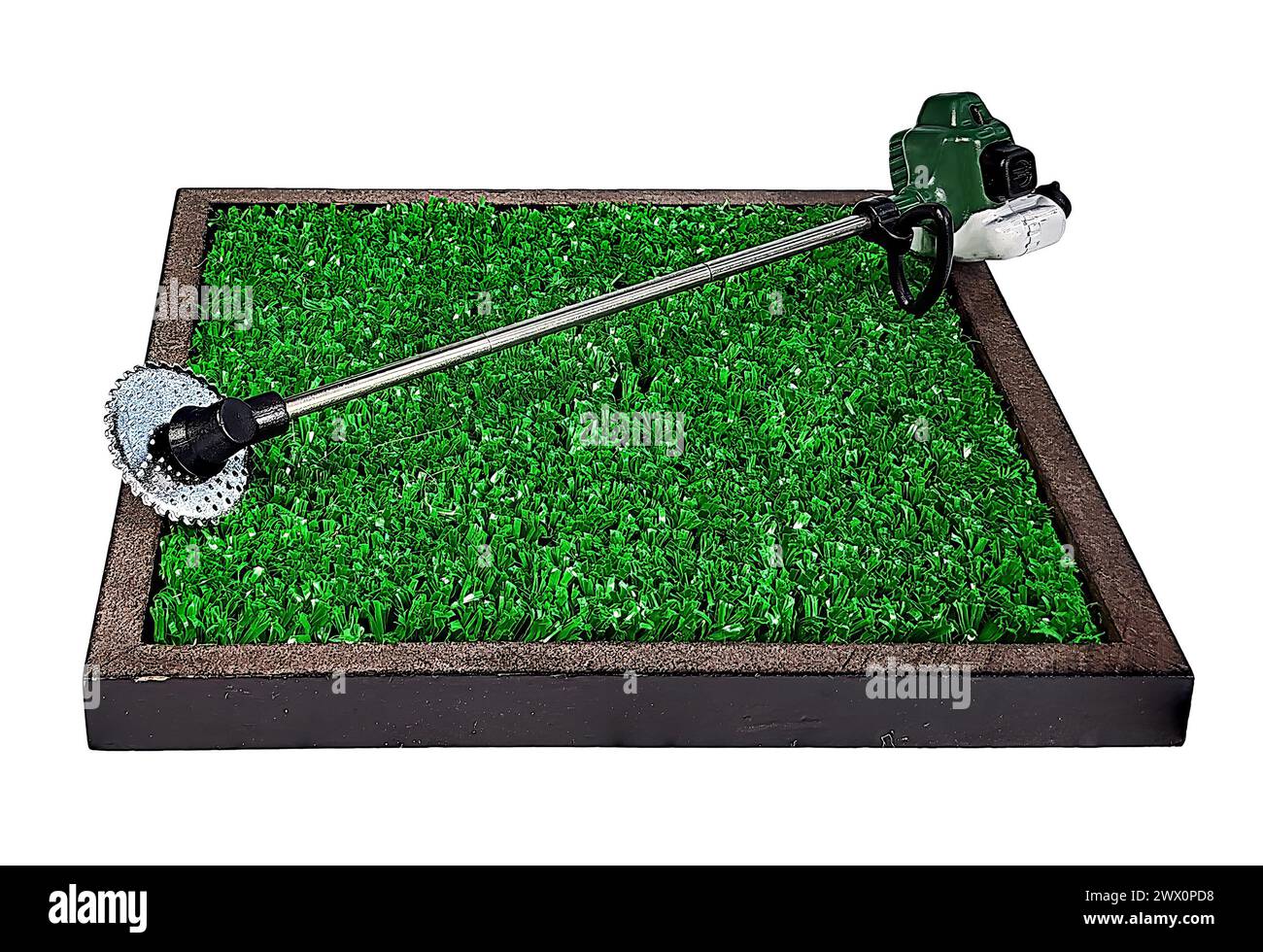 A patch of green grass growing with a weed whacker Stock Photo - Alamy