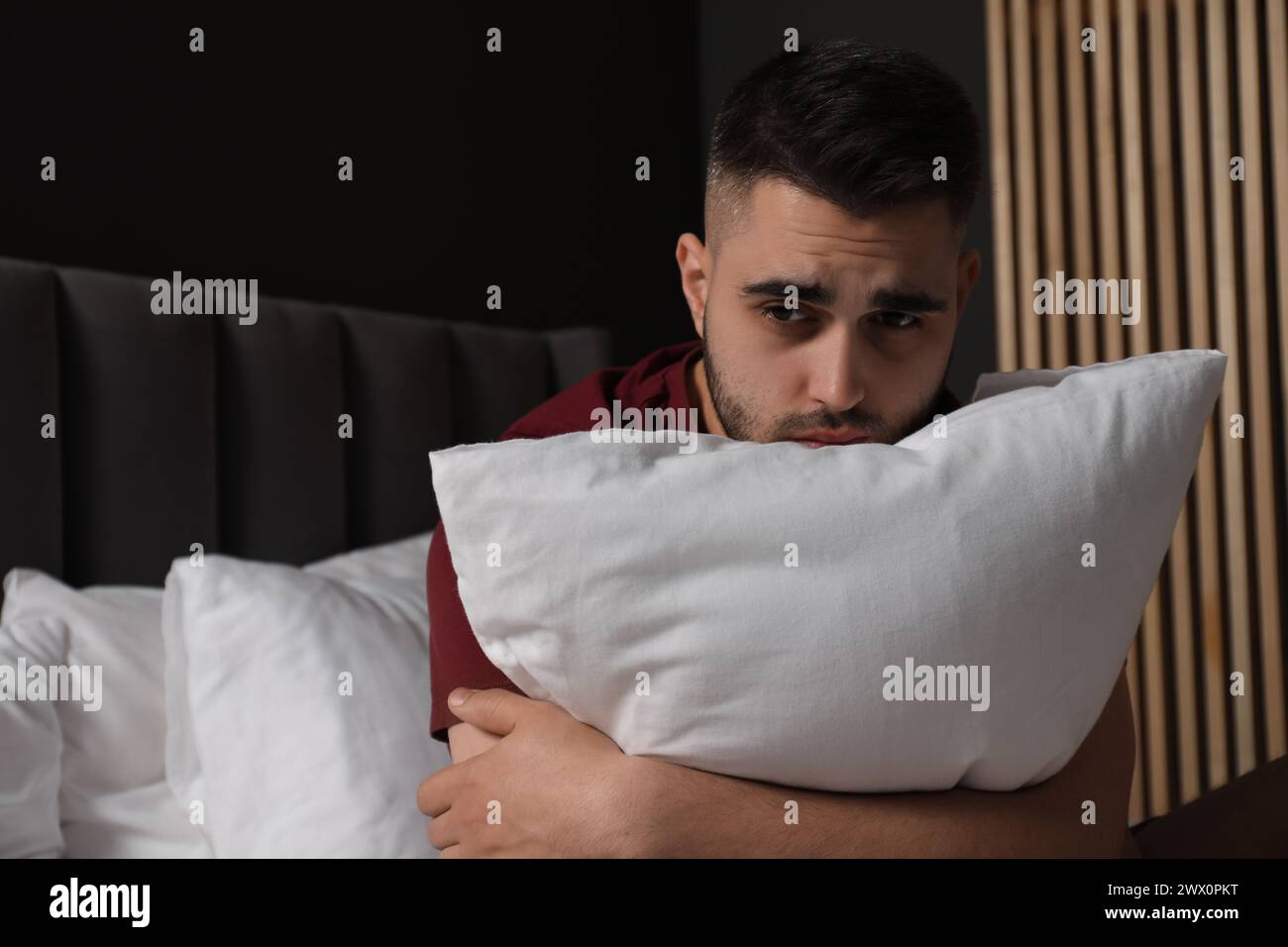 Sad unhappy man hugging pillow hi-res stock photography and images - Alamy