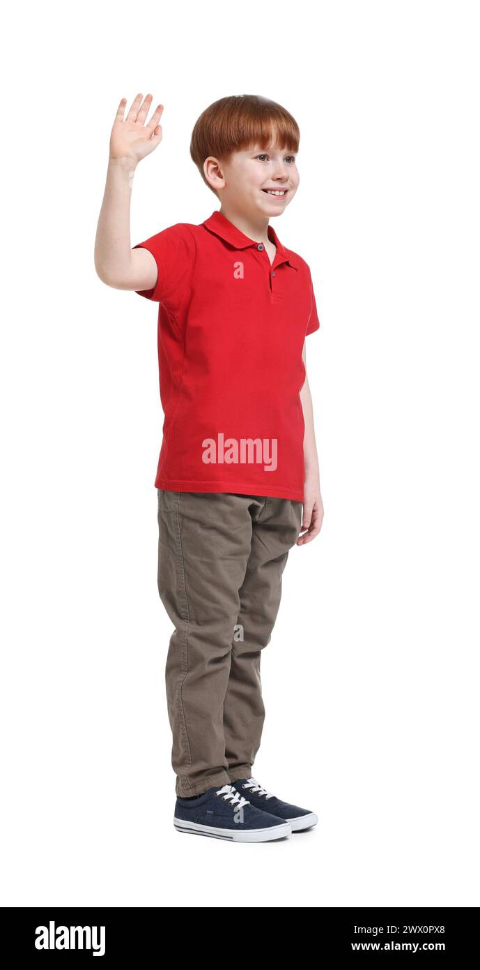 Smiling little boy waving hand on white background Stock Photo - Alamy