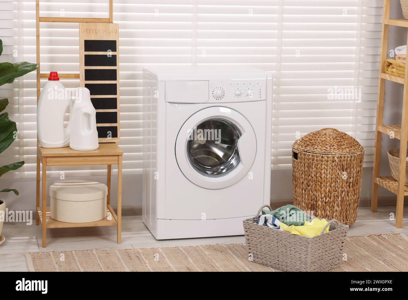 Laundry room interior with washing machine and baskets Stock Photo - Alamy