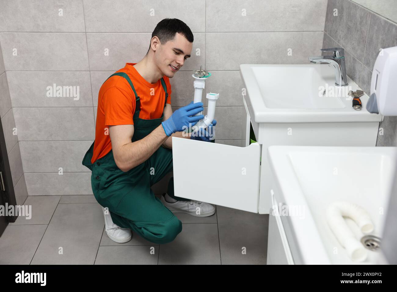 Plumber wearing gloves repairing hi-res stock photography and images ...