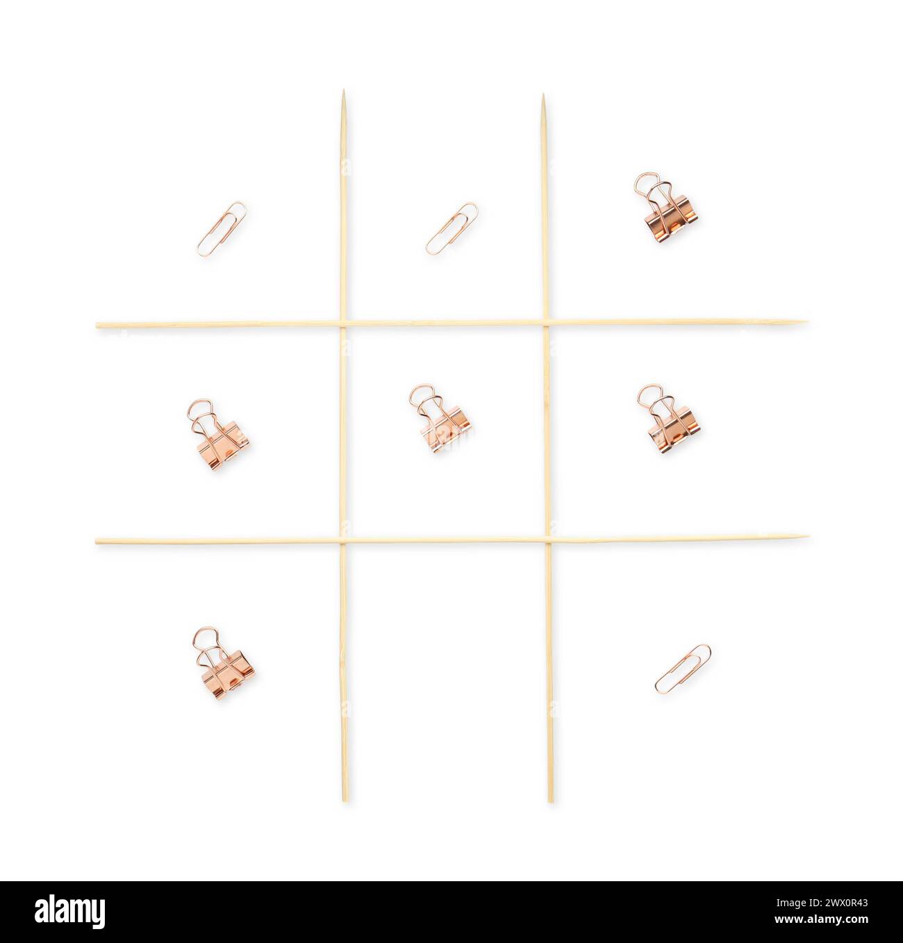 Tic tac toe game made with paper clips isolated on white, top view ...