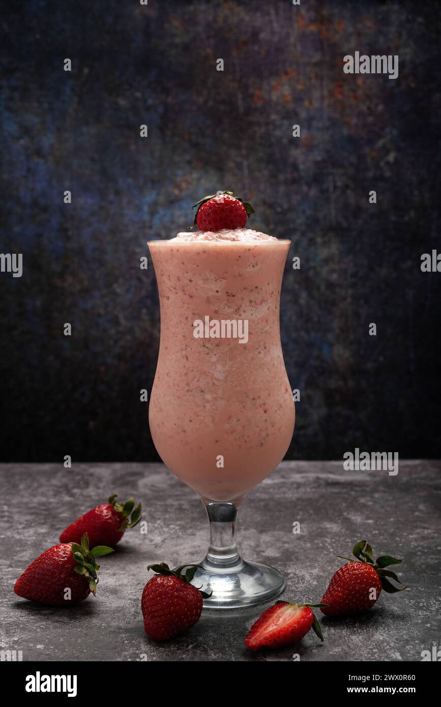 Strawberry milkshake on cement table with dark background. Strawberry ...