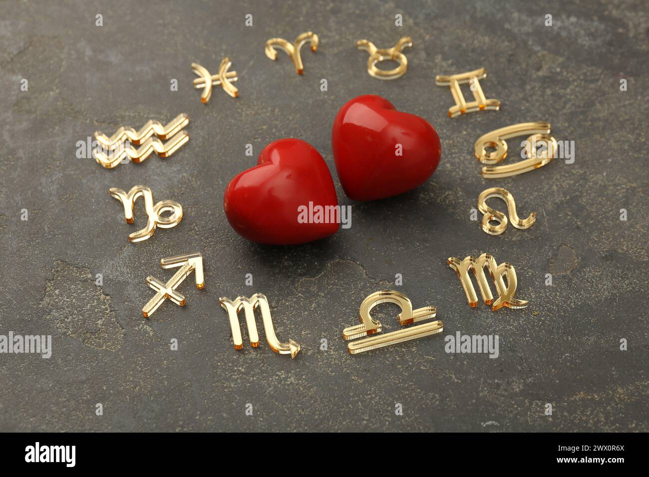 Zodiac signs and red hearts on grey textured background Stock Photo - Alamy