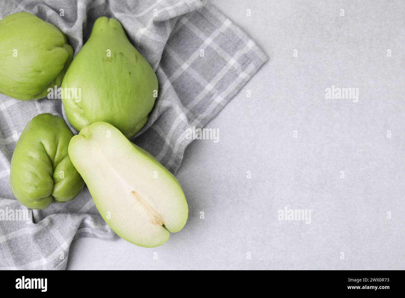Cut and whole chayote on gray table, top view. Space for text Stock ...