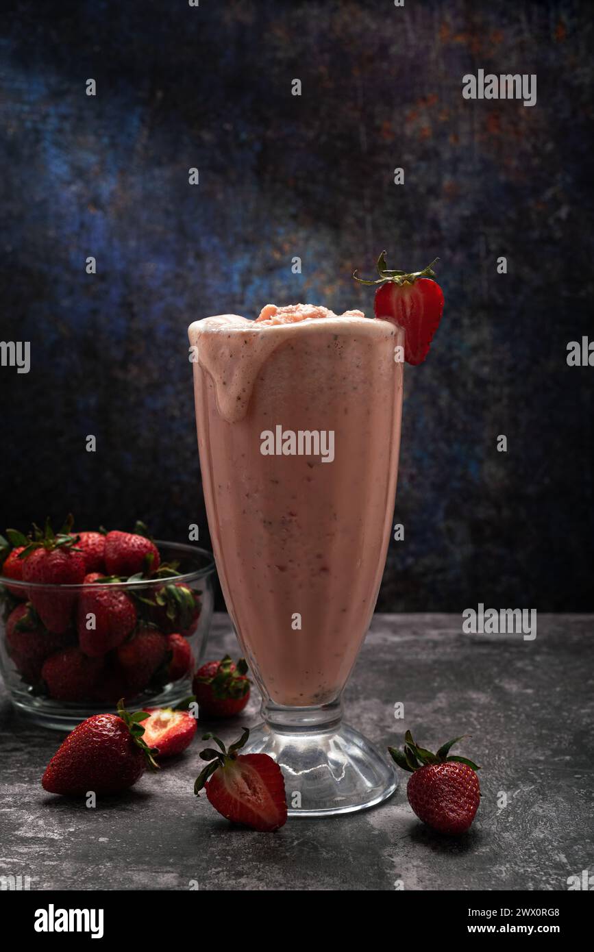 Strawberry milkshake on cement table with dark background. Strawberry ...