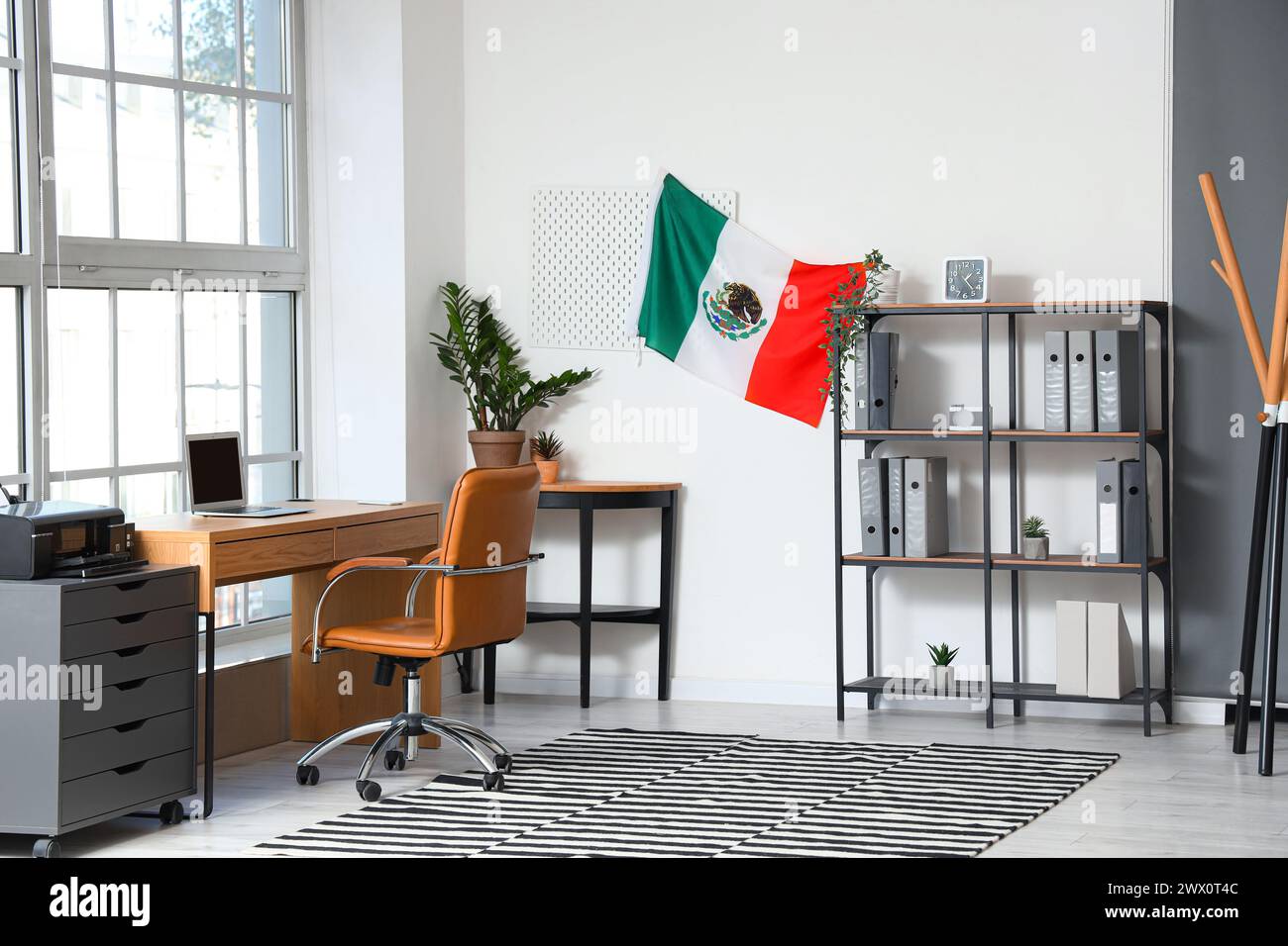 Interior of modern office with workplace and hanging Mexican flag Stock ...