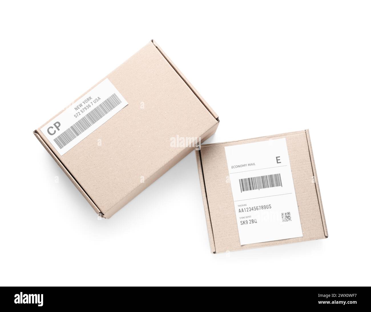 Cardboard packages with shipping labels and barcodes on white ...