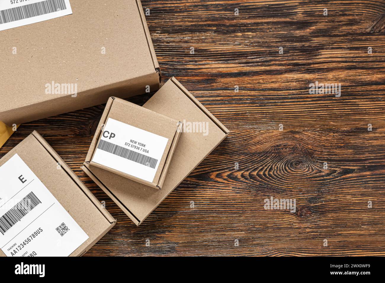 Cardboard packages with labels and barcodes on wooden table Stock Photo ...