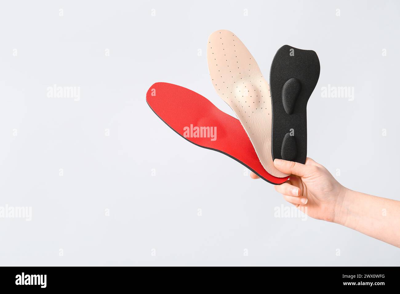 Female hands holding orthopedic insoles isolated on white background ...