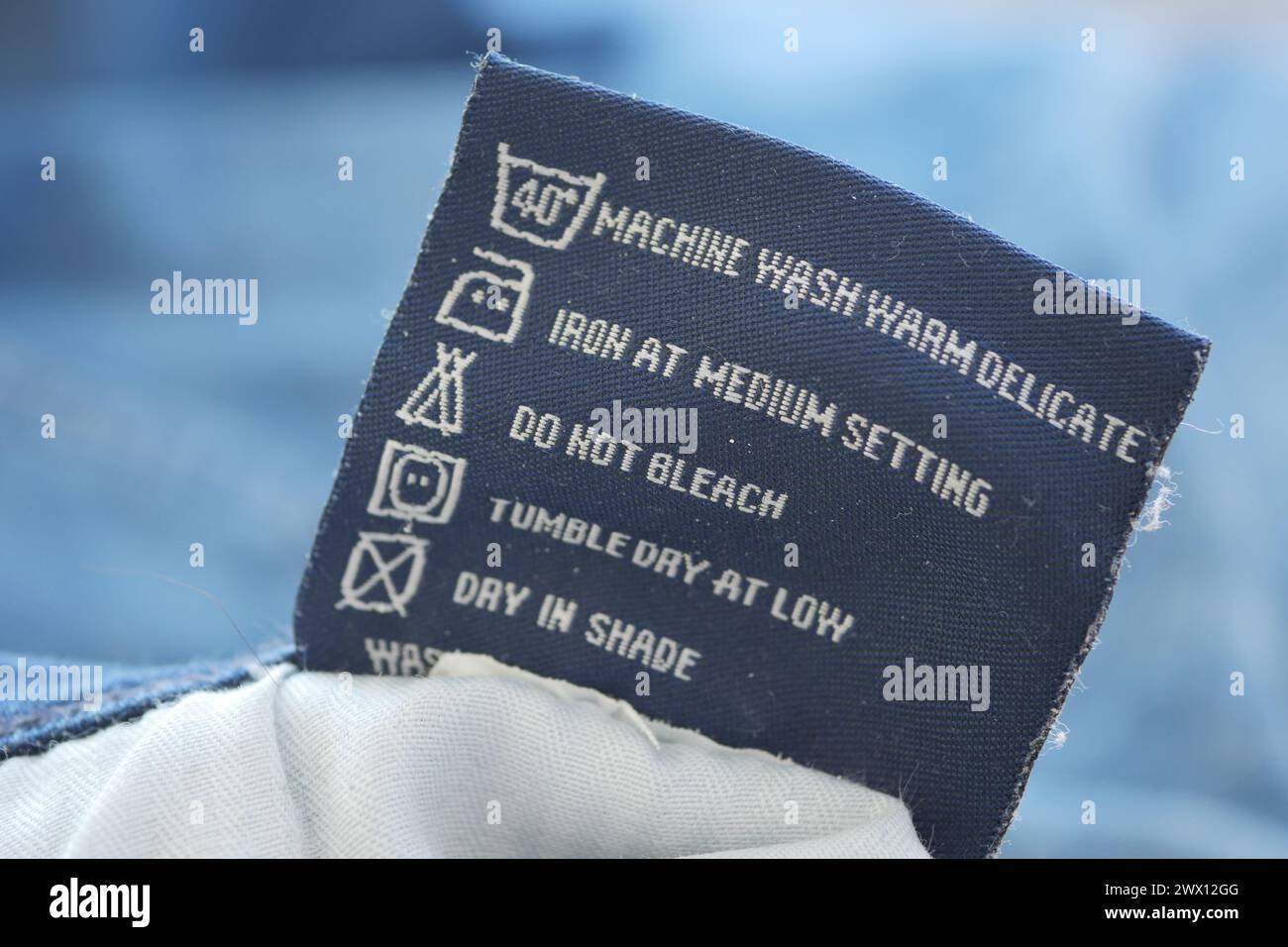 Clothing label with care symbols on a cloth Stock Photo - Alamy