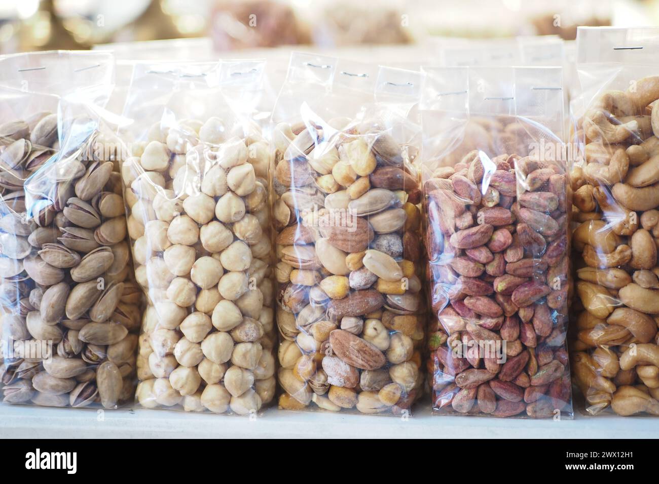 many mixed nuts in a plastic packet on shelf Stock Photo - Alamy