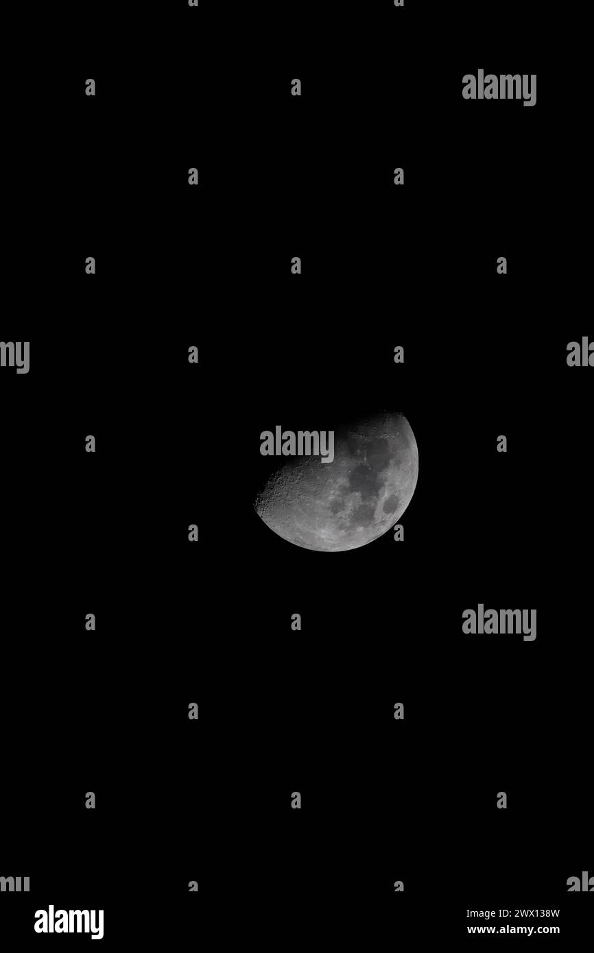 First quarter moon in the night sky Stock Photo - Alamy