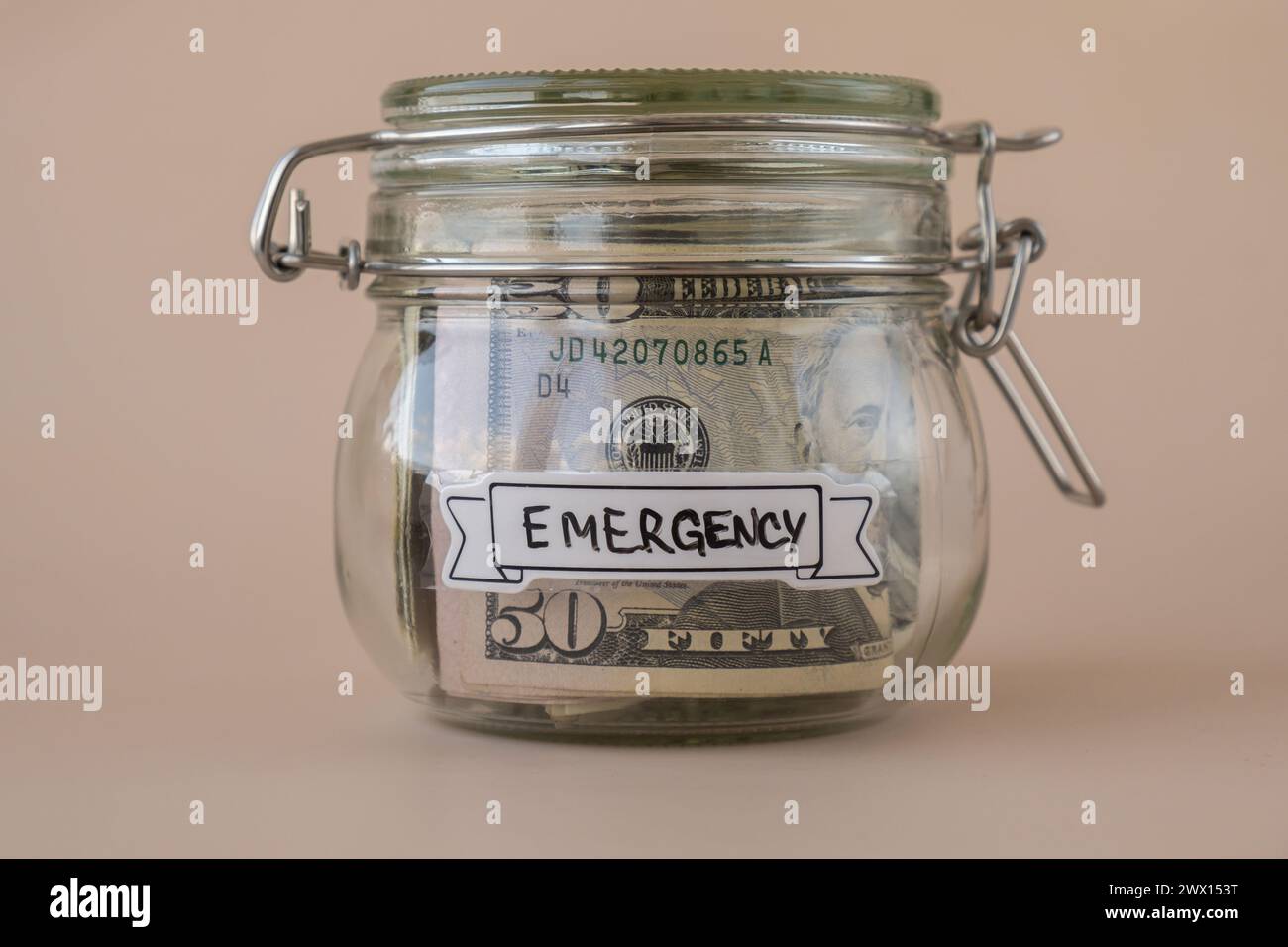 Glass jar full of American currency dollars cash banknote with text ...