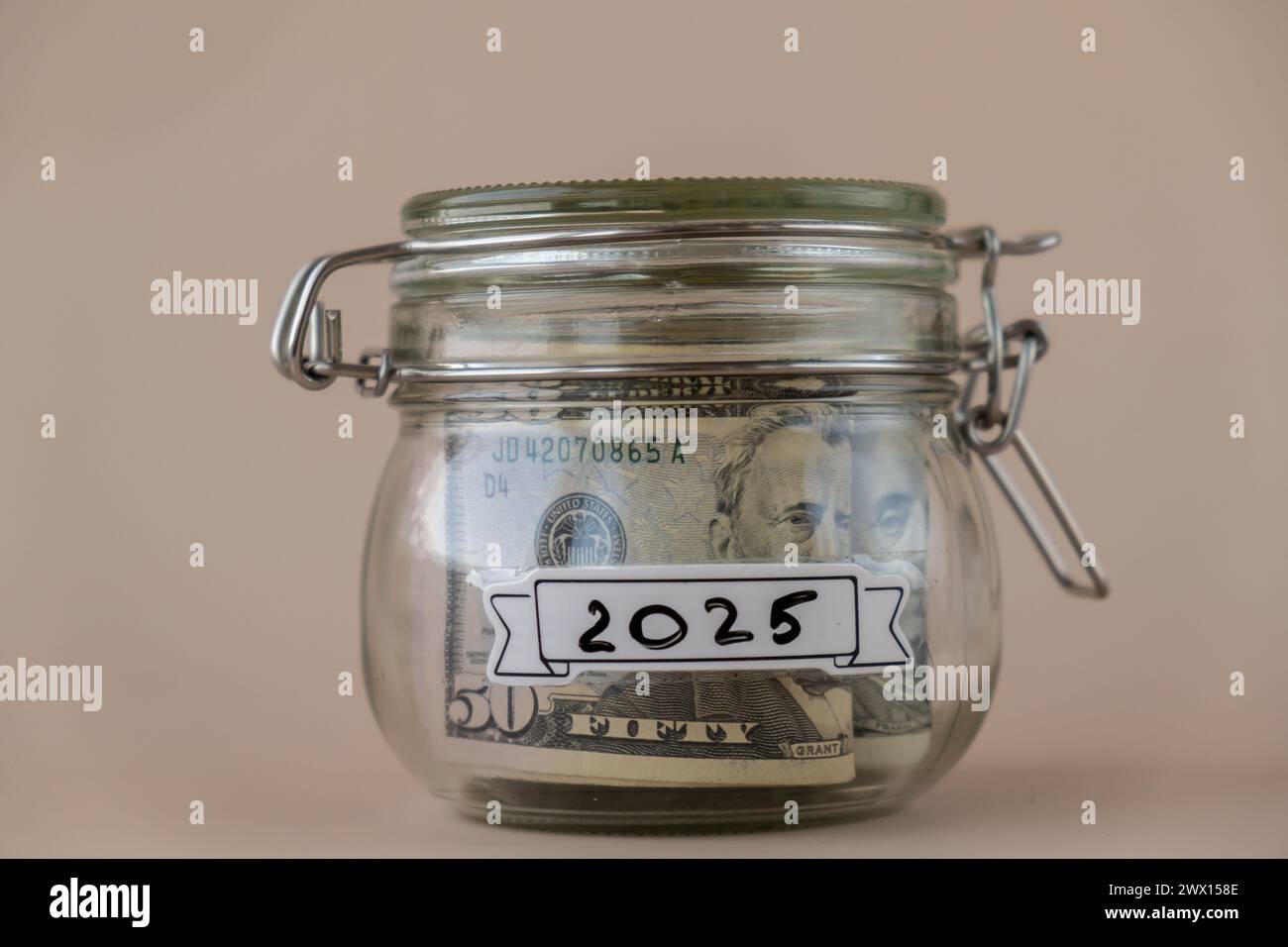 Glass jar full of American currency dollars cash banknote with text ...