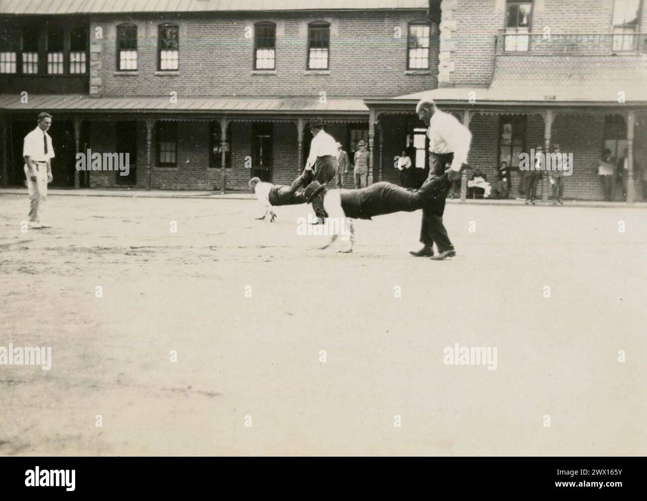 Men Playing “Wheel-Barrel” ca. 1912-1917 Stock Photo - Alamy
