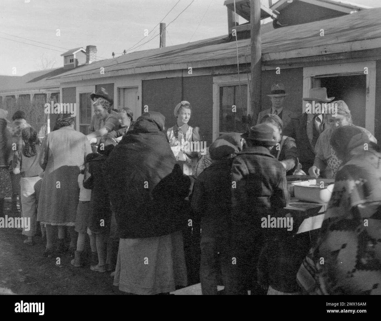 People standing in a line on a cold day, possibly on the Wind River ...