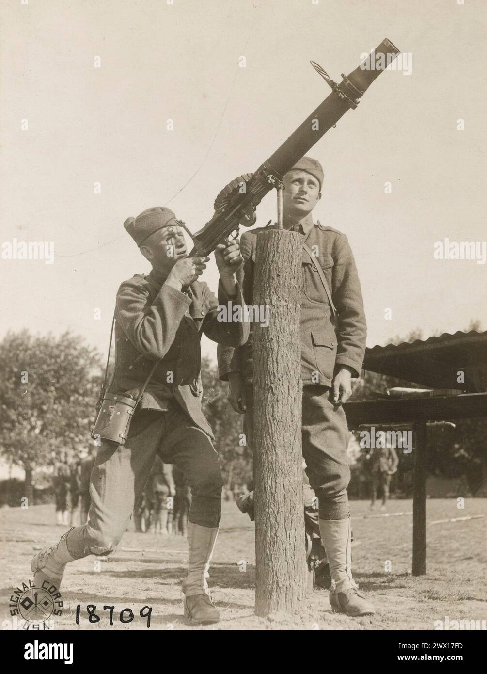 Two soldiers standing next to a Lewis Machine Gun used for anti ...