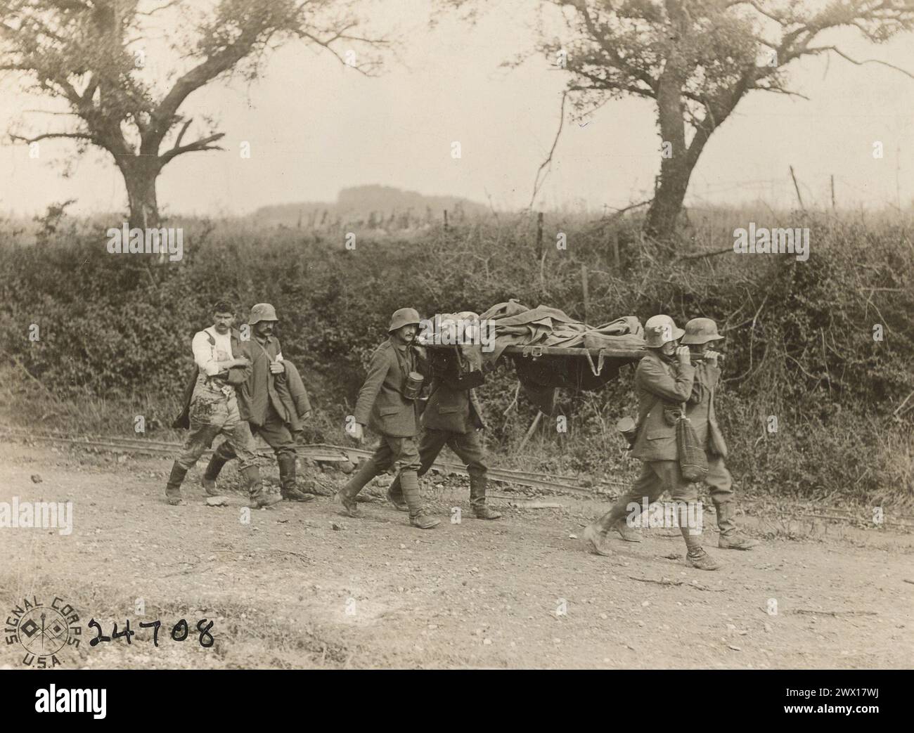 German prisoners walking on a road near Boureuilles France, carrying a ...