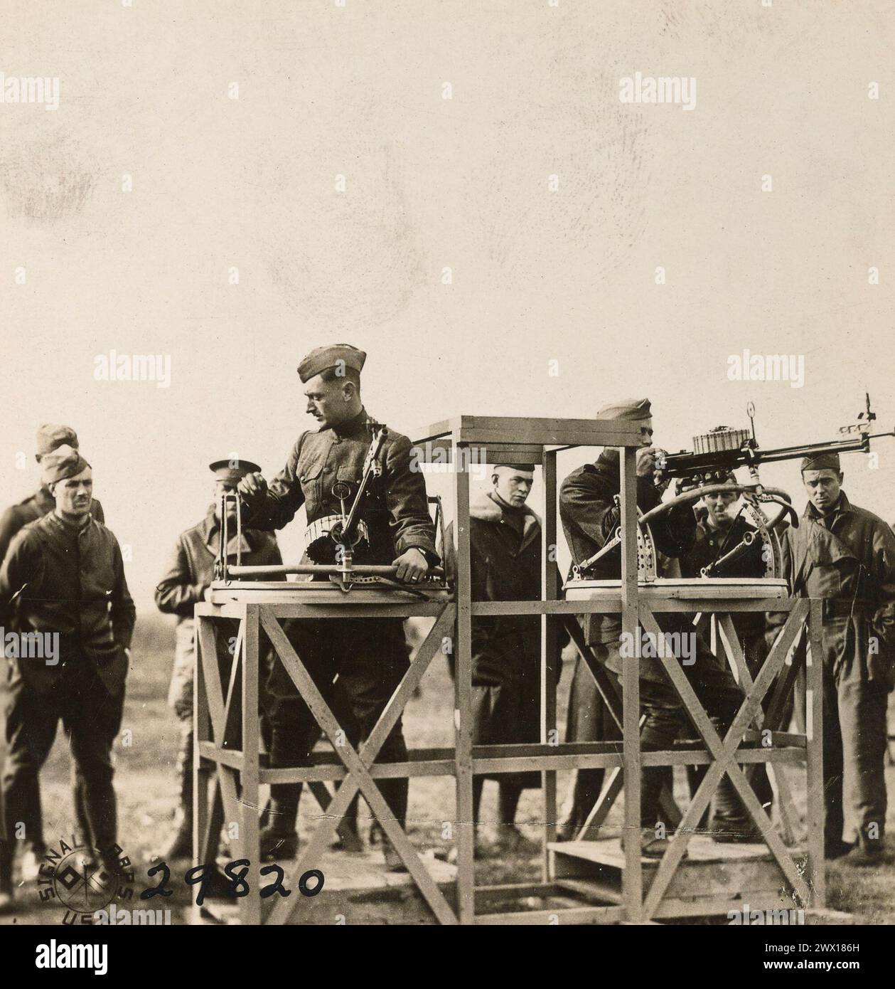 An instructor teaches soldiers how to use a machine gun mounted on a ...