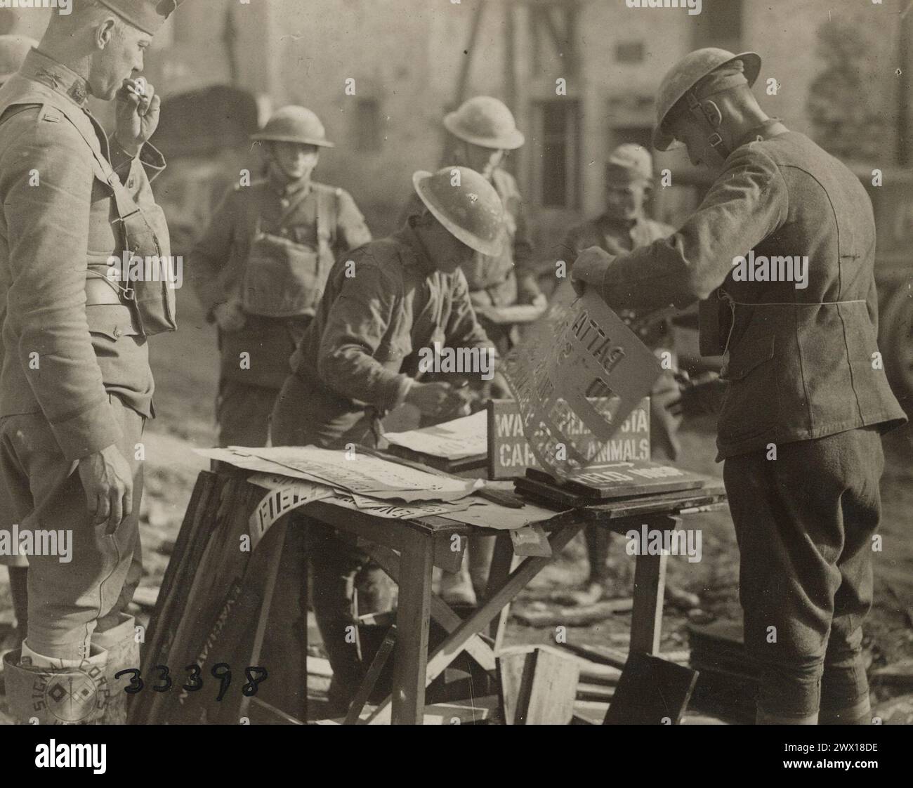 A soldier uses a stencil to make road signs ca. 1918 Stock Photo - Alamy