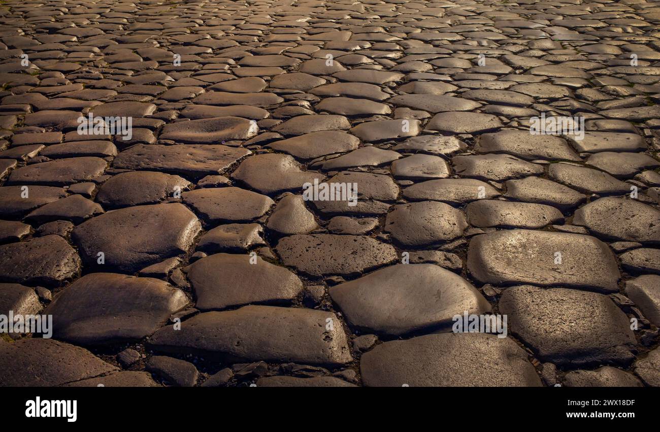 Old shiny cobble stone street pavement Stock Photo - Alamy