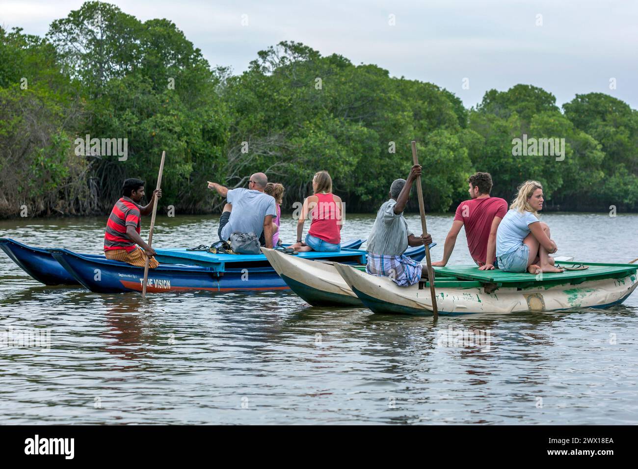 Foreign tourists enjoy a late afternoon pontoon boat ride past ...